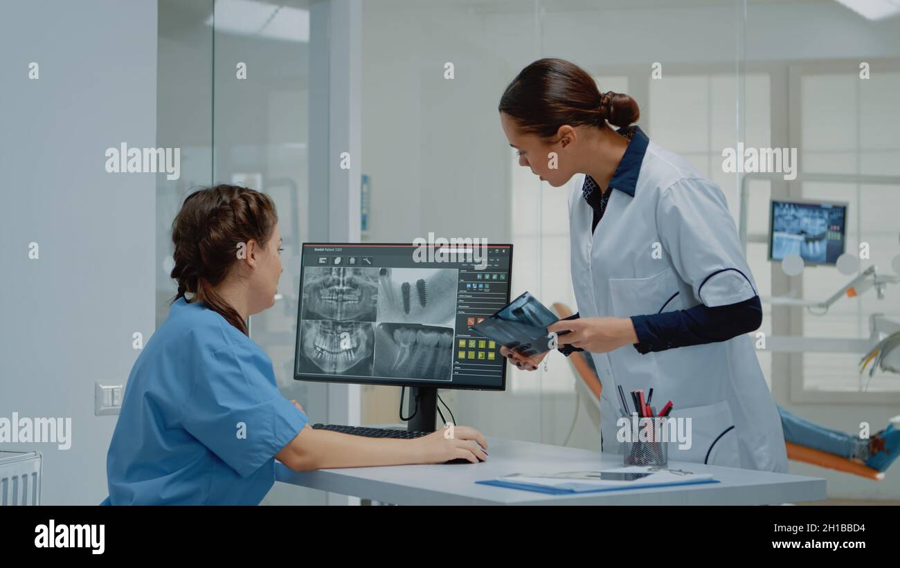 Dentist holding dentition x ray scan comparing to radiography on ...