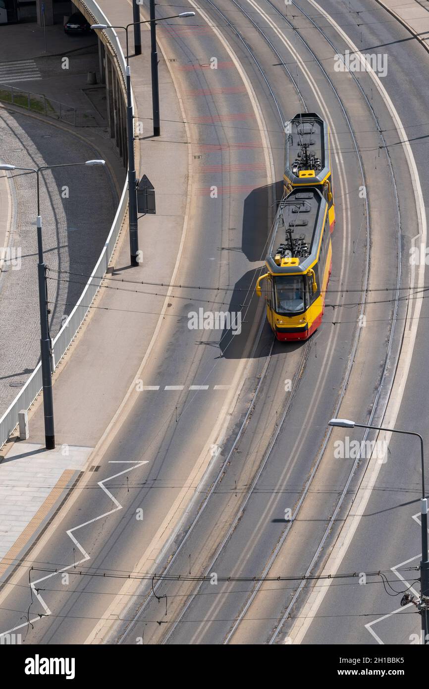 Tramline tracks with a tram, an empty street and a sidewalk, public ...