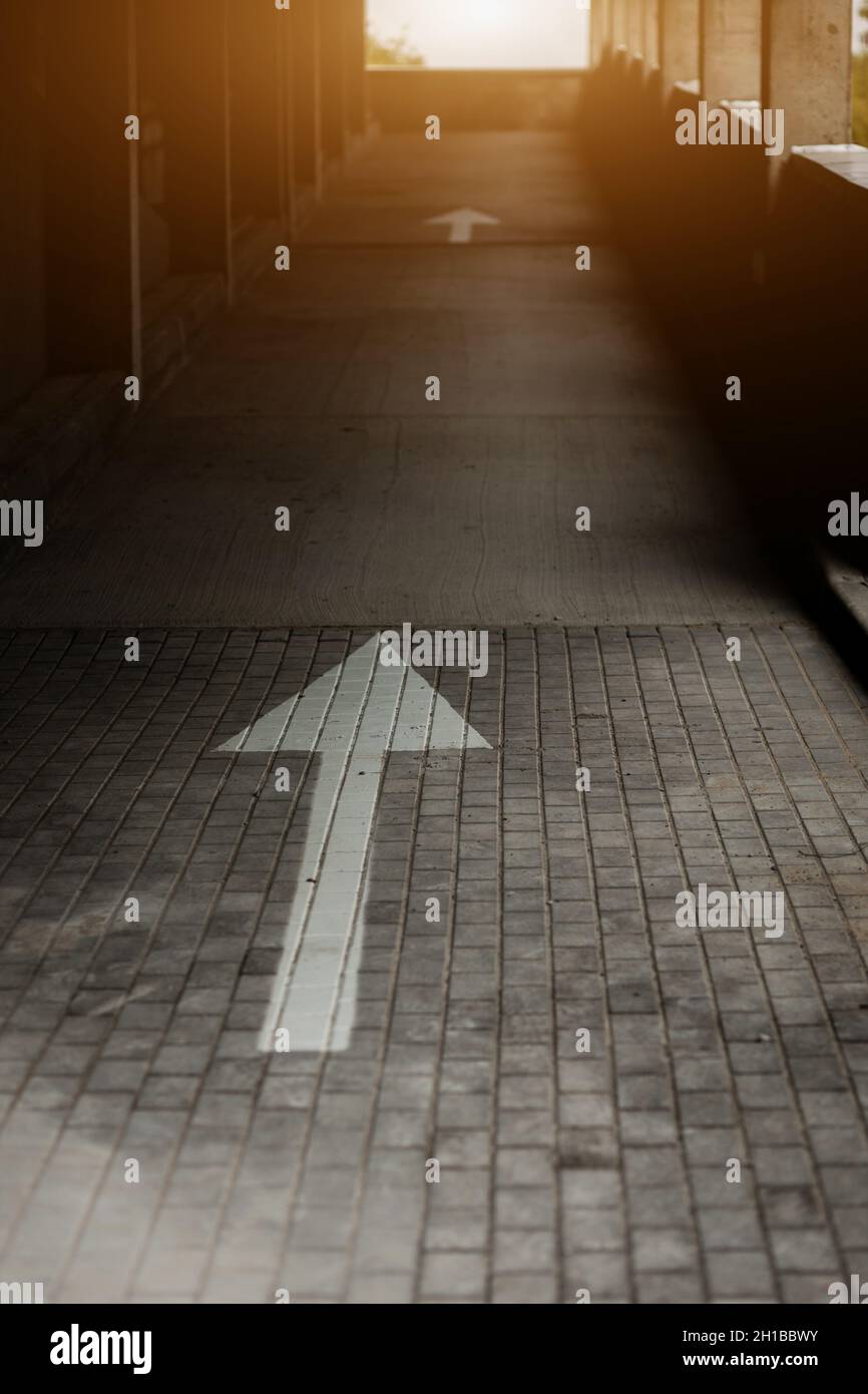 arrow sign on the parking lot. the direction of movement of cars in the ...