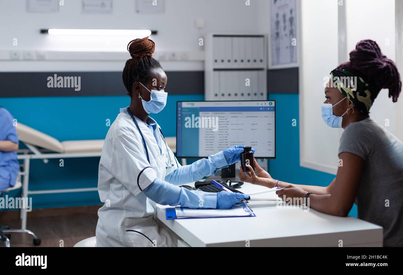 African american doctor with protective face mask against covid19 ...