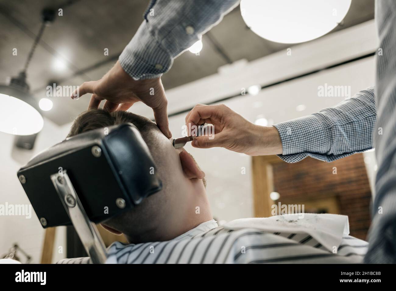 Man having a shave at the barber shop Stock Photo - Alamy