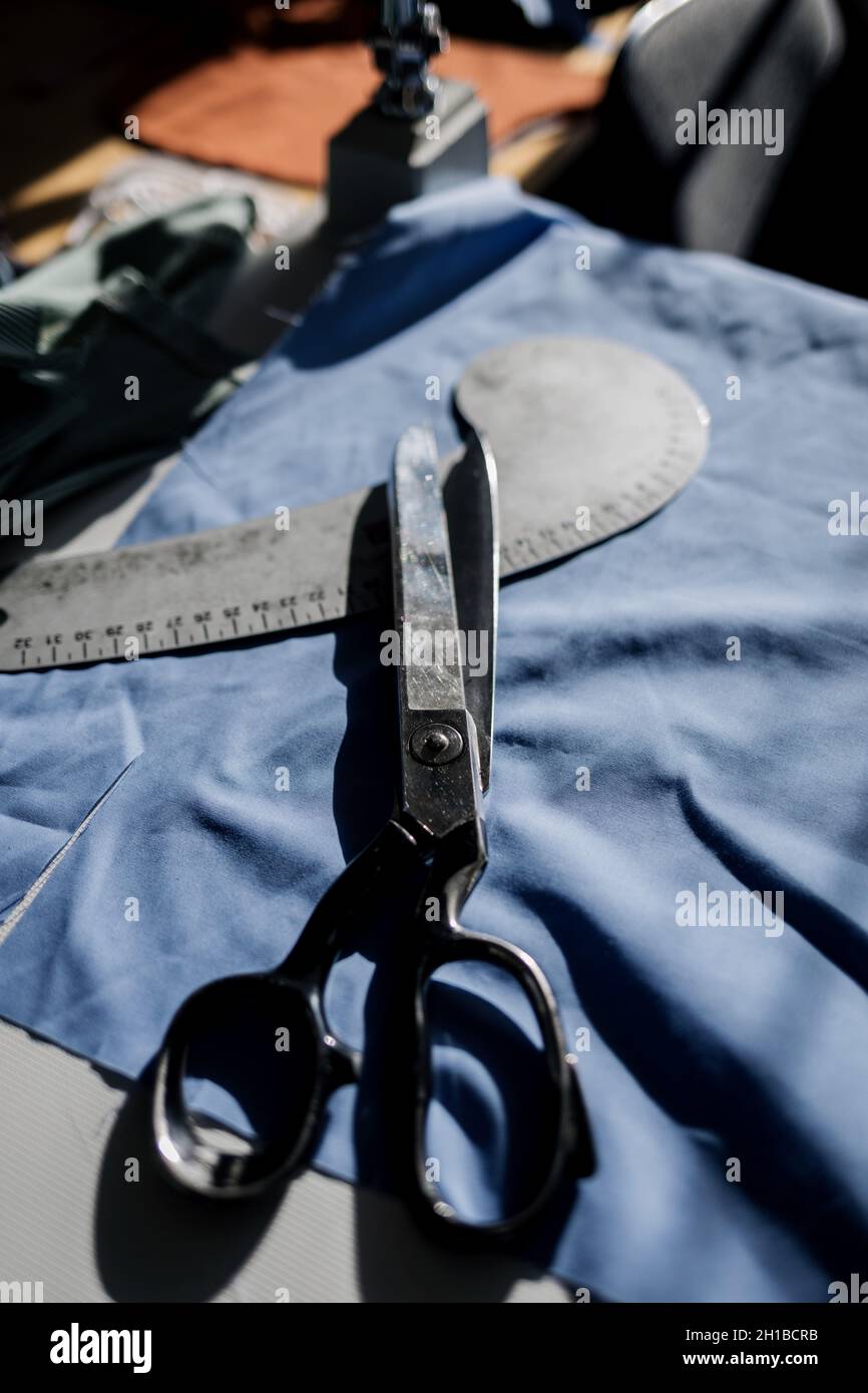 Sewing textile or cloth. Scissors on fabric. Work table of a tailor ...