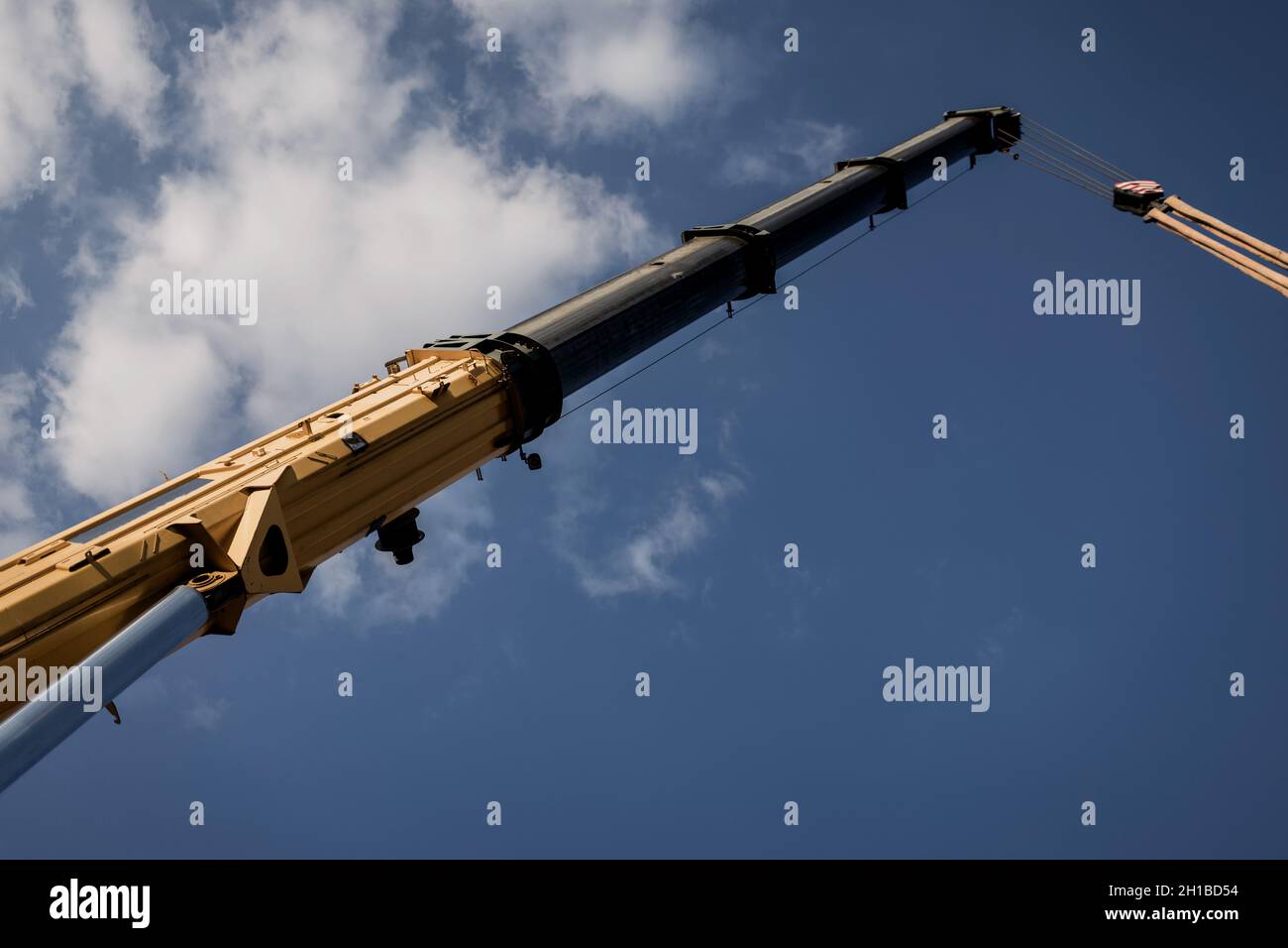 Mobile truck crane boom above blue sky Stock Photo - Alamy