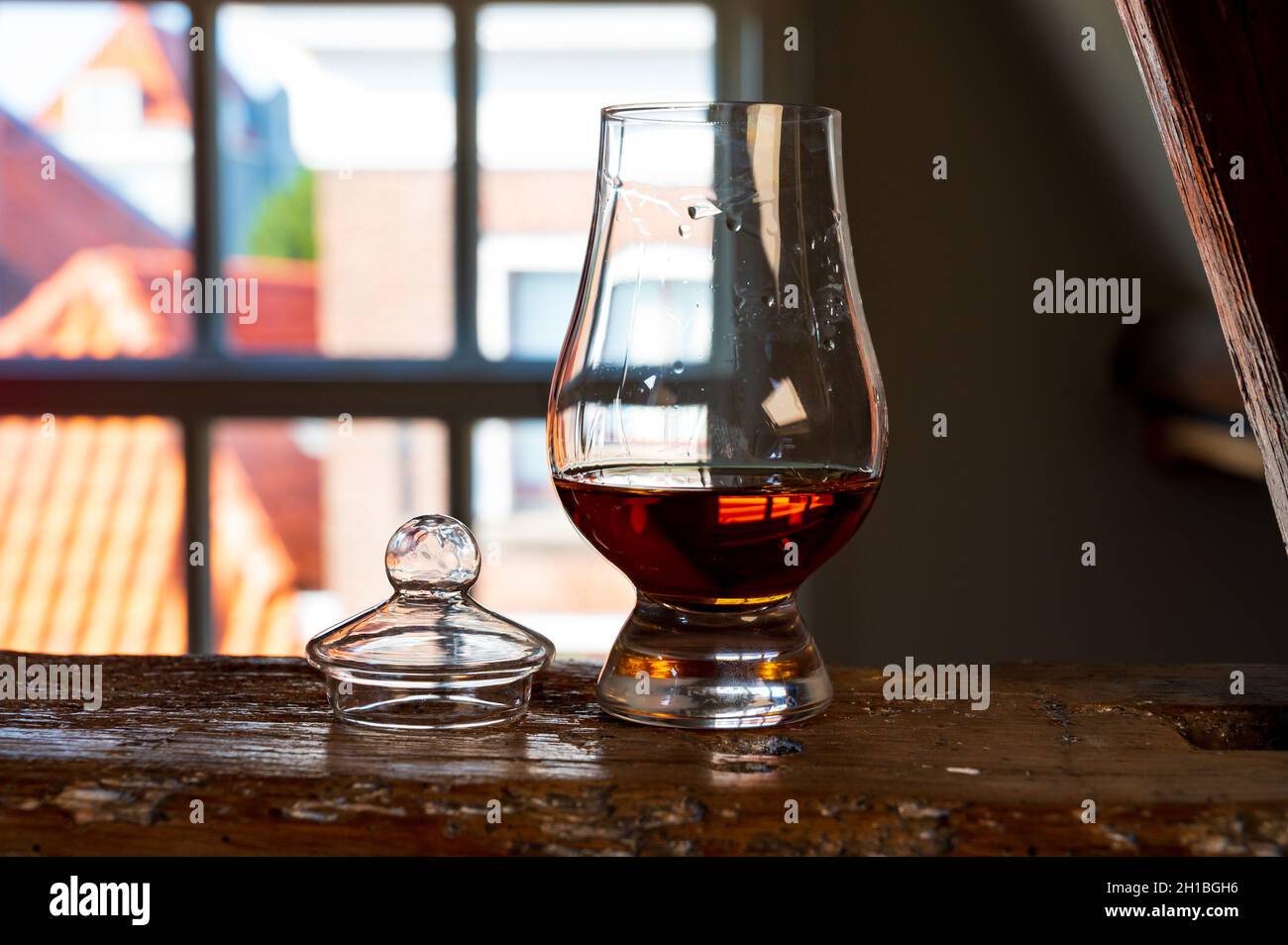 Dram of single malt scotch whisky served in tasting glass with view on ...