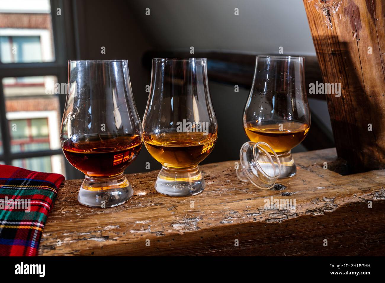 Dram of single malt scotch whisky served in tasting glass with view on ...