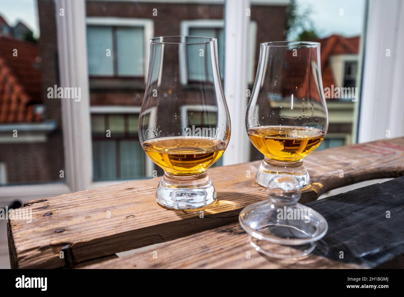 Dram of single malt scotch whisky served in tasting glass with view on ...