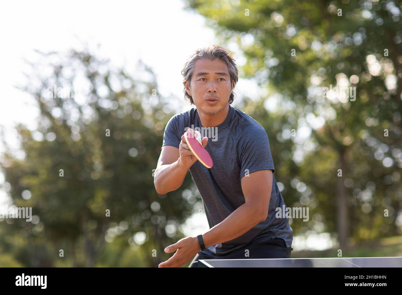 Man playing table tennis outdoors hi-res stock photography and images ...