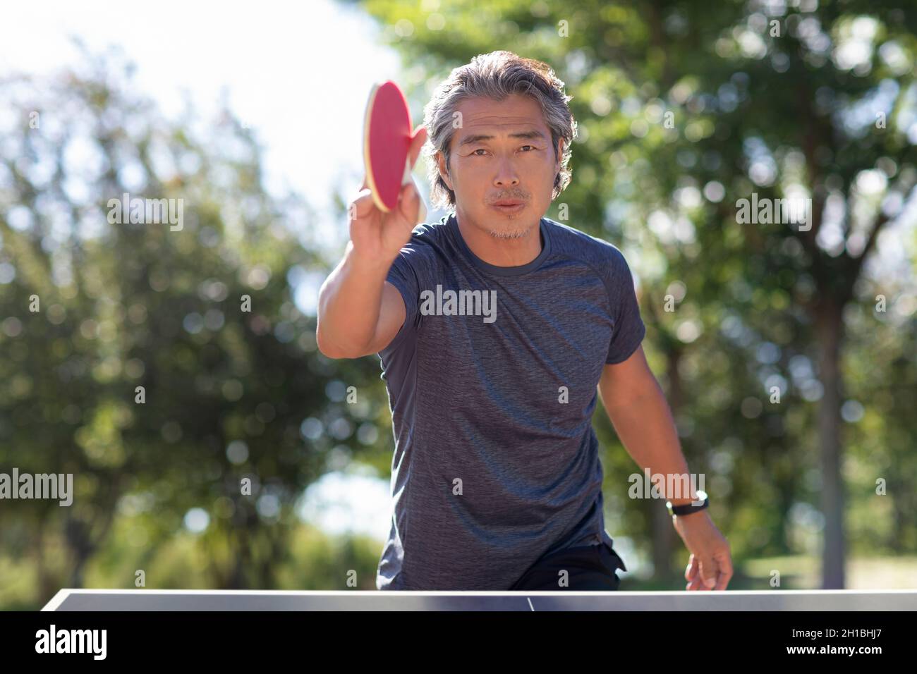 Man playing table tennis outdoors hi-res stock photography and images ...