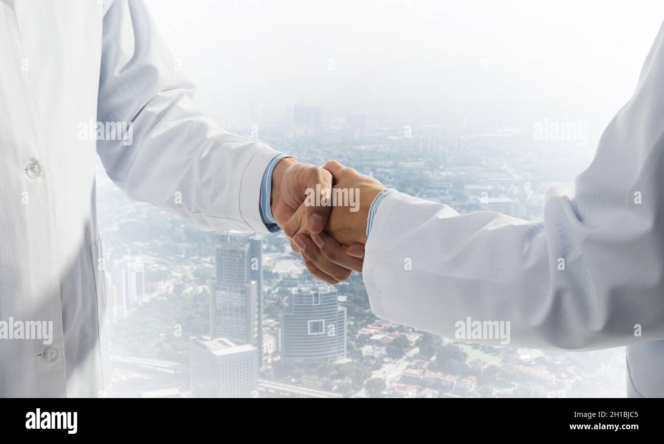 Close-up of the handshake between the two medics Stock Photo - Alamy