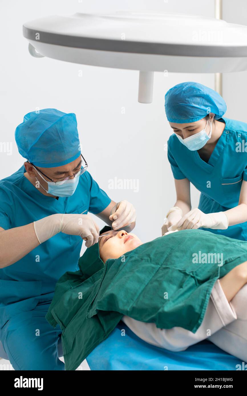 Mid adult woman receiving facial plastic surgery Stock Photo - Alamy