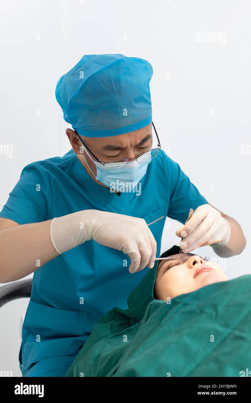 Mid adult woman receiving facial plastic surgery Stock Photo - Alamy