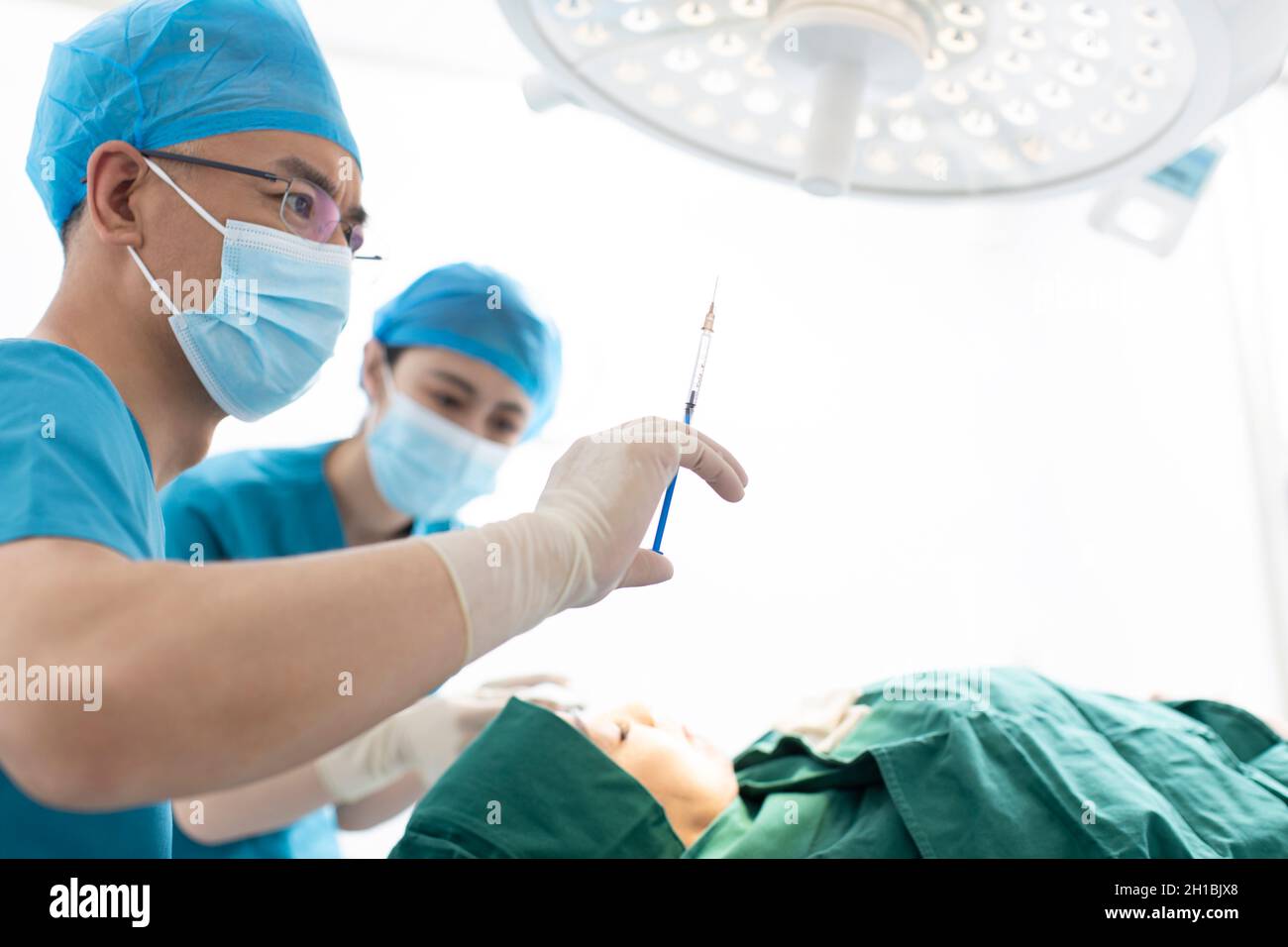 Mid adult woman receiving facial plastic surgery Stock Photo - Alamy