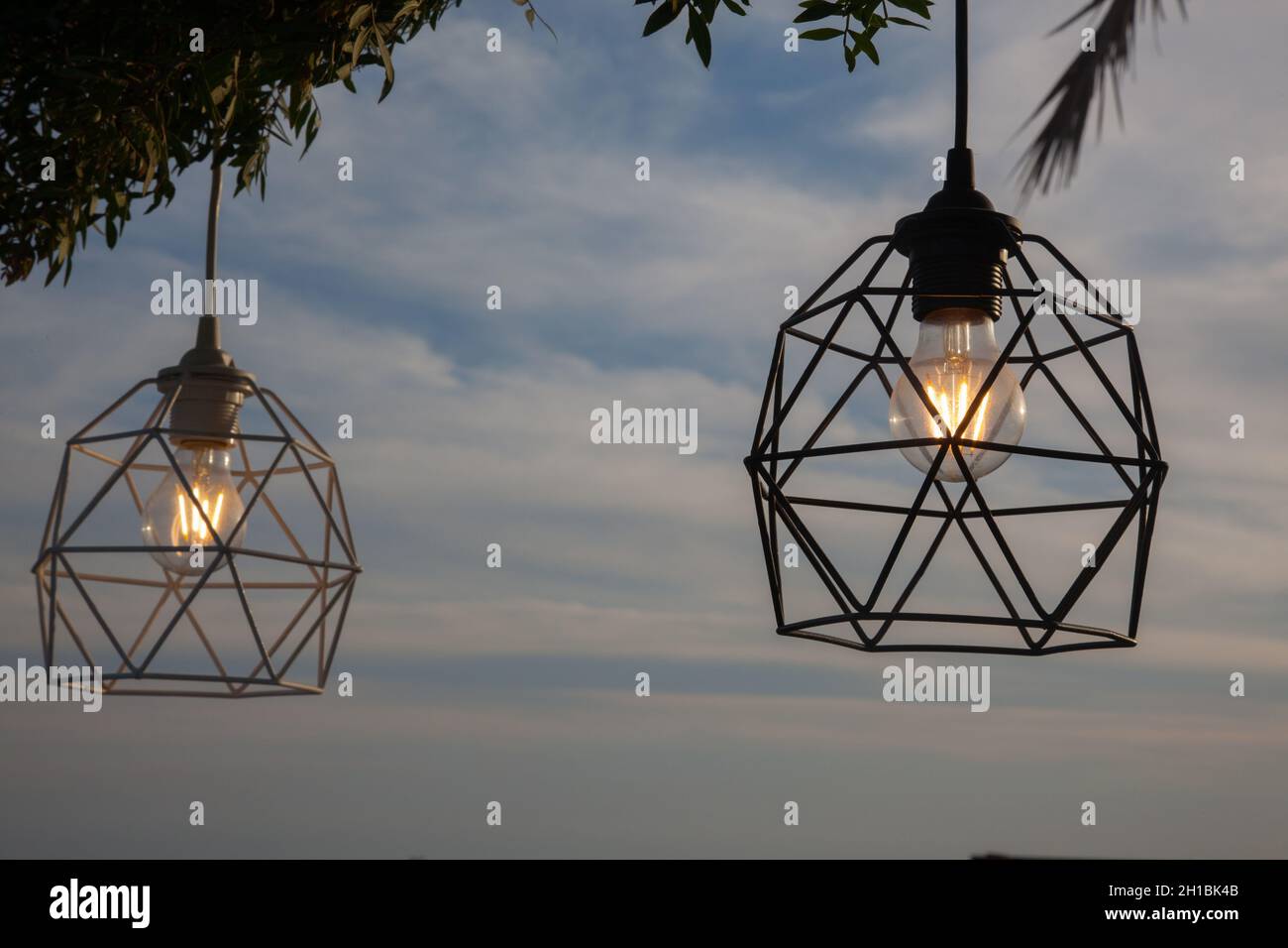 Decorative filament bulb on a terrace at dusk Stock Photo - Alamy