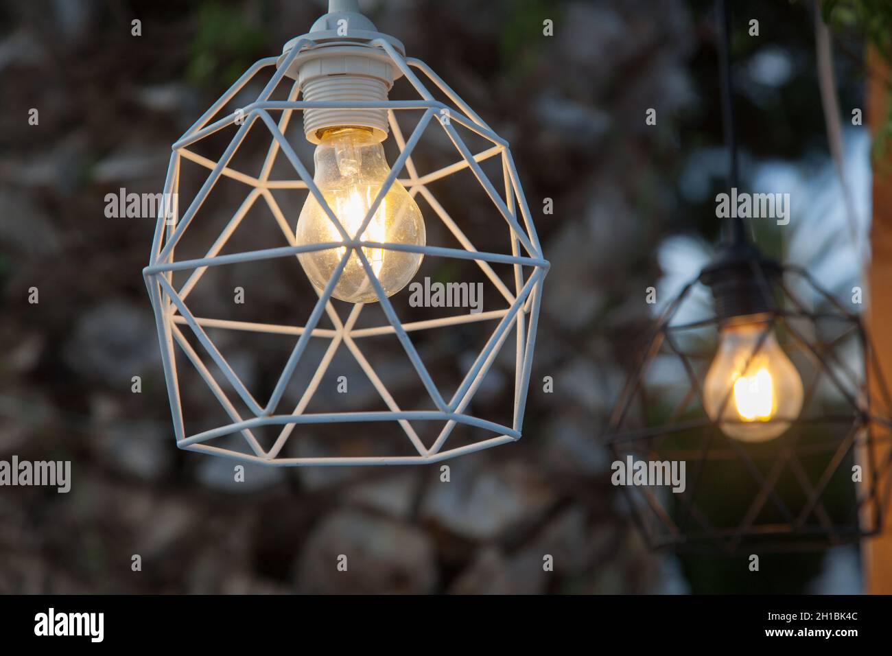 Decorative filament bulb on a terrace at dusk Stock Photo - Alamy