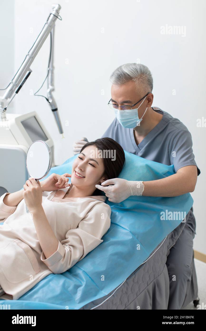 Young woman receiving face treatment in hospital Stock Photo - Alamy