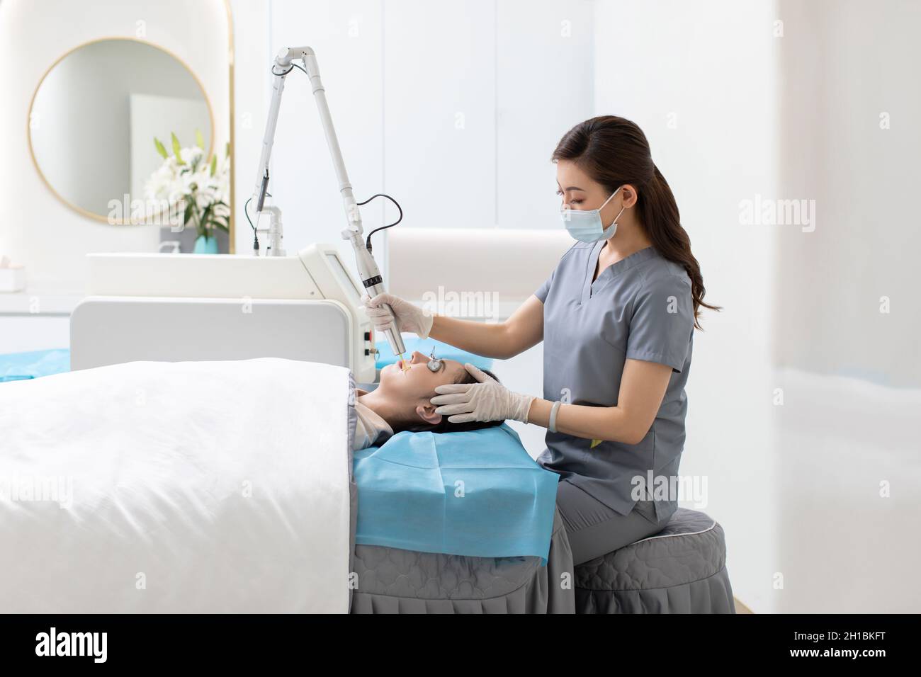Young woman receiving face treatment in hospital Stock Photo - Alamy