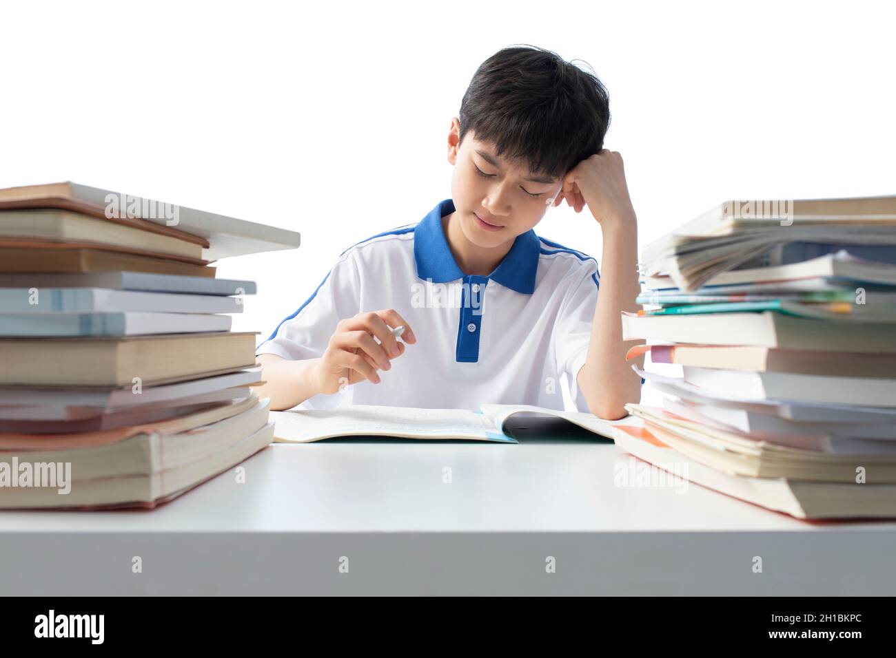 Teenage boy doing homework Stock Photo - Alamy