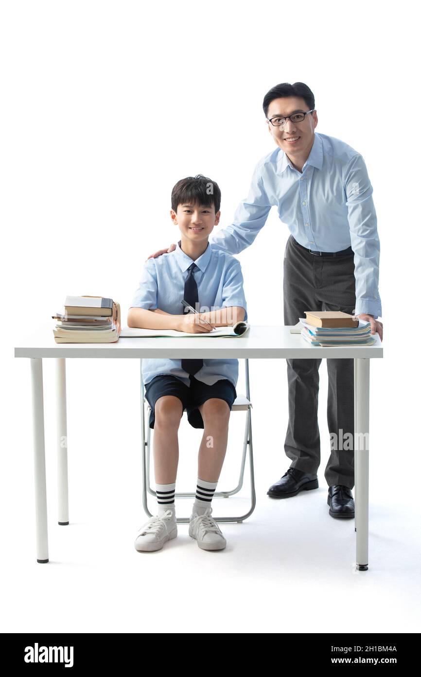 Teacher helping boy with homework Stock Photo - Alamy