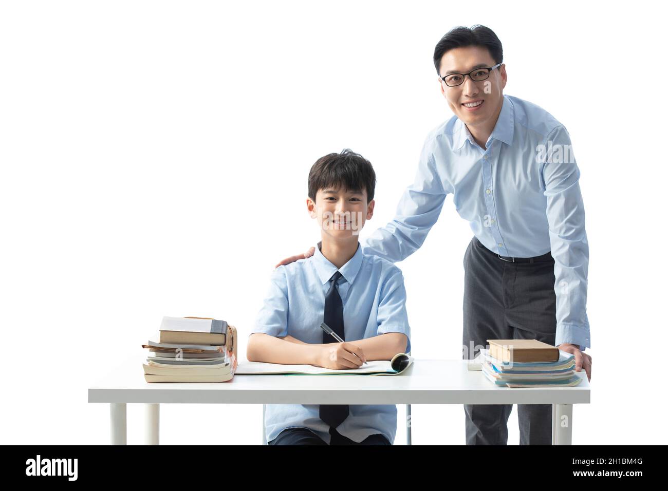 Teacher helping boy with homework Stock Photo - Alamy