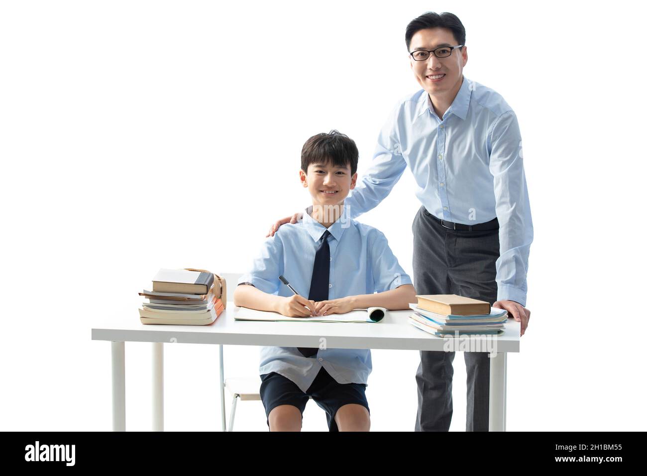 Teacher helping boy with homework Stock Photo - Alamy