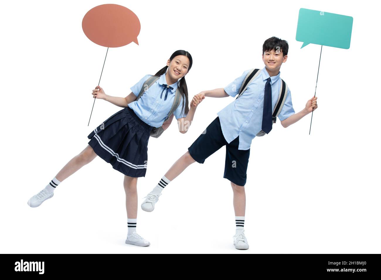 Cheerful students holding speech bubbles Stock Photo - Alamy