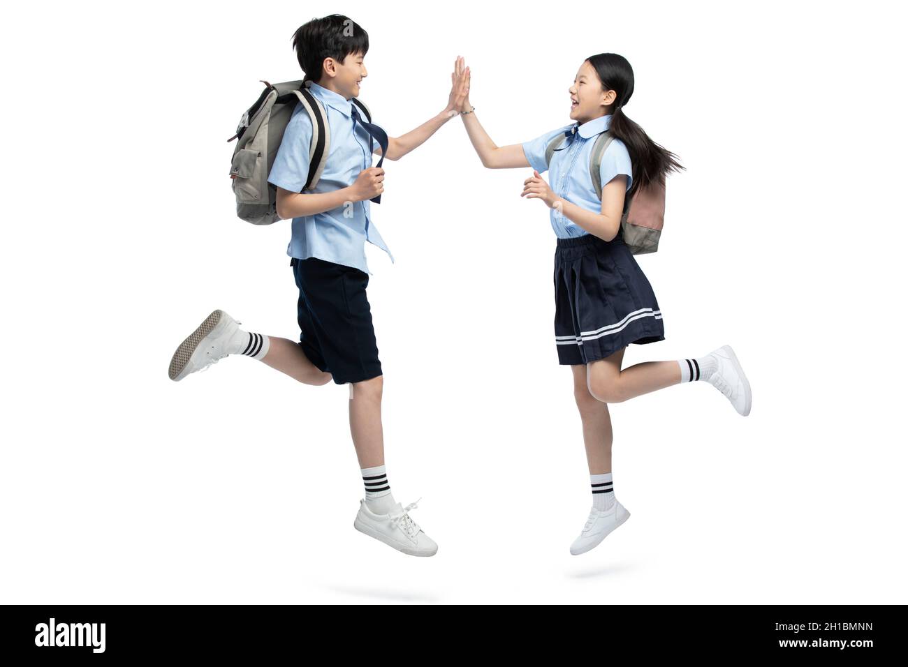 Cheerful students high fiving Stock Photo - Alamy