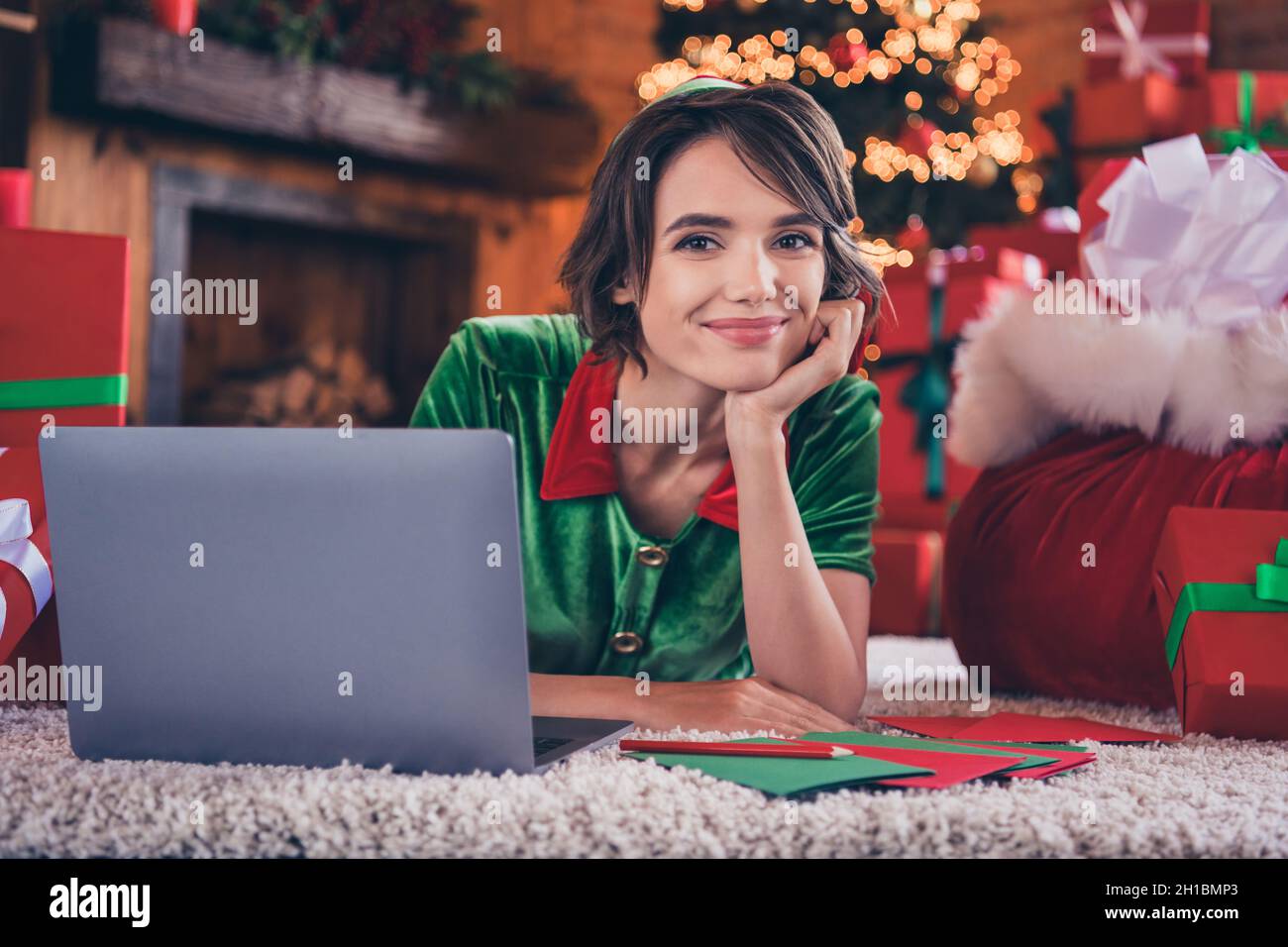 Photo of sweet pretty young woman dressed green costume smiling typing ...