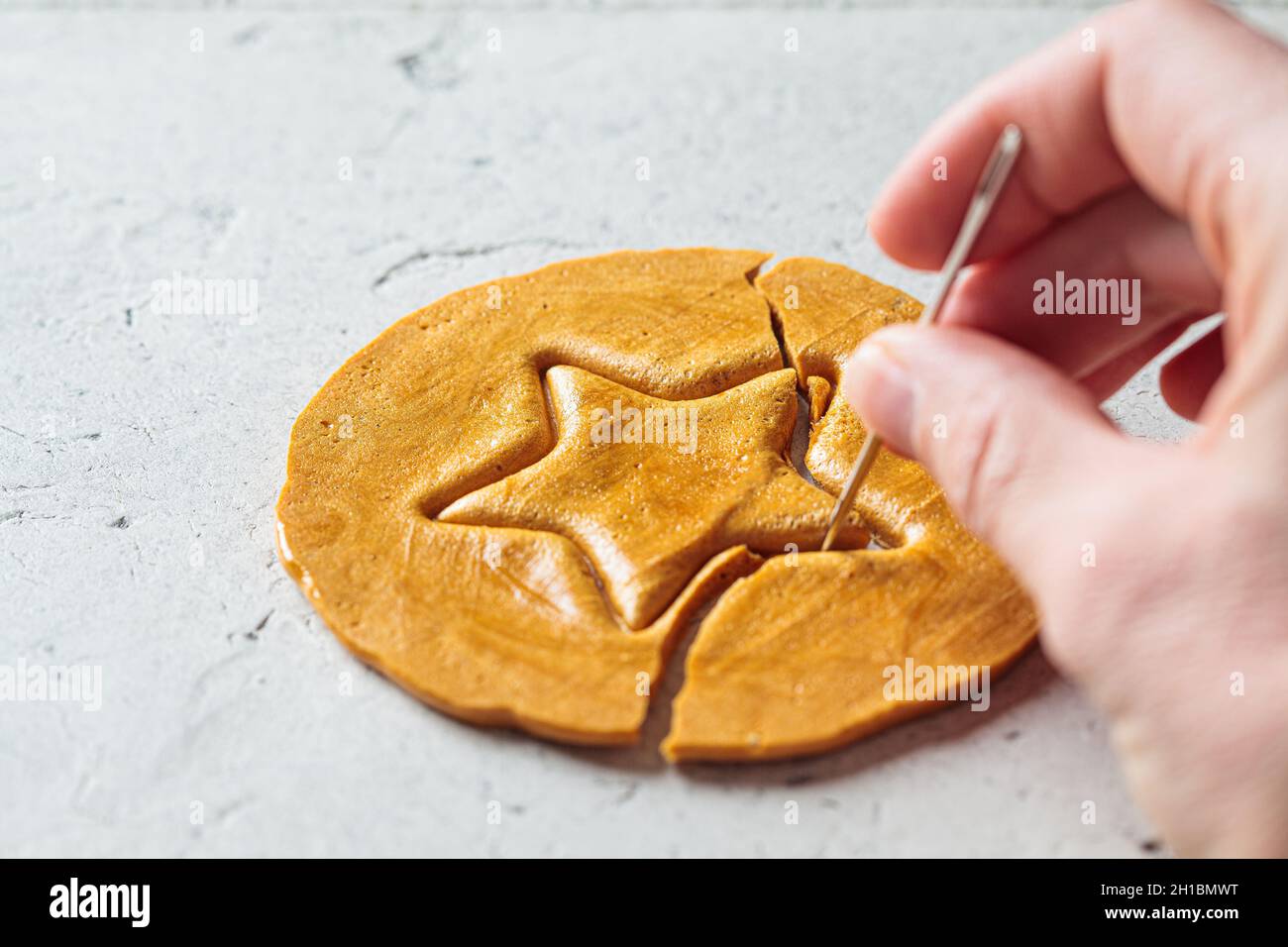 Dalgona Candy - South Korean treat. Round sugar cookie with a star ...