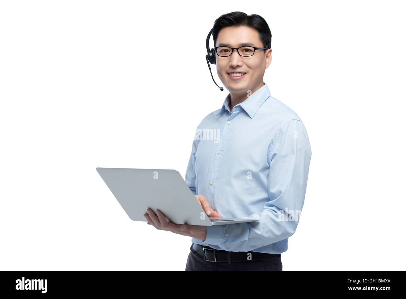 Happy male teacher using laptop Stock Photo - Alamy