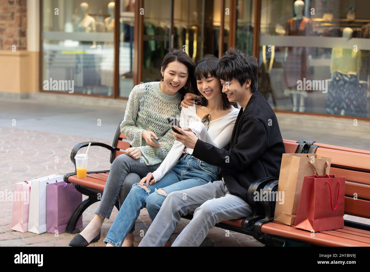 Happy young friends shopping together Stock Photo - Alamy