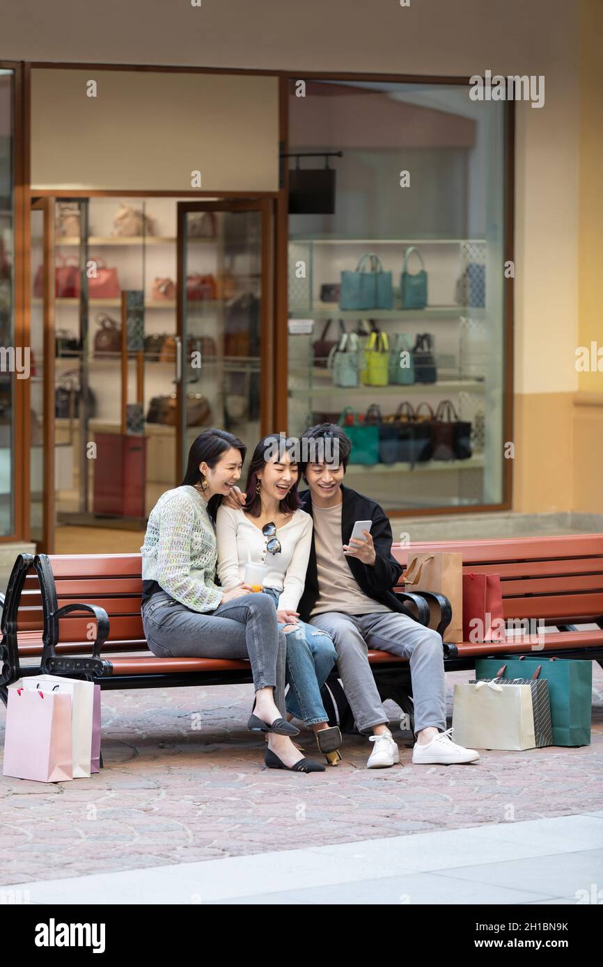 Happy young friends shopping together Stock Photo - Alamy