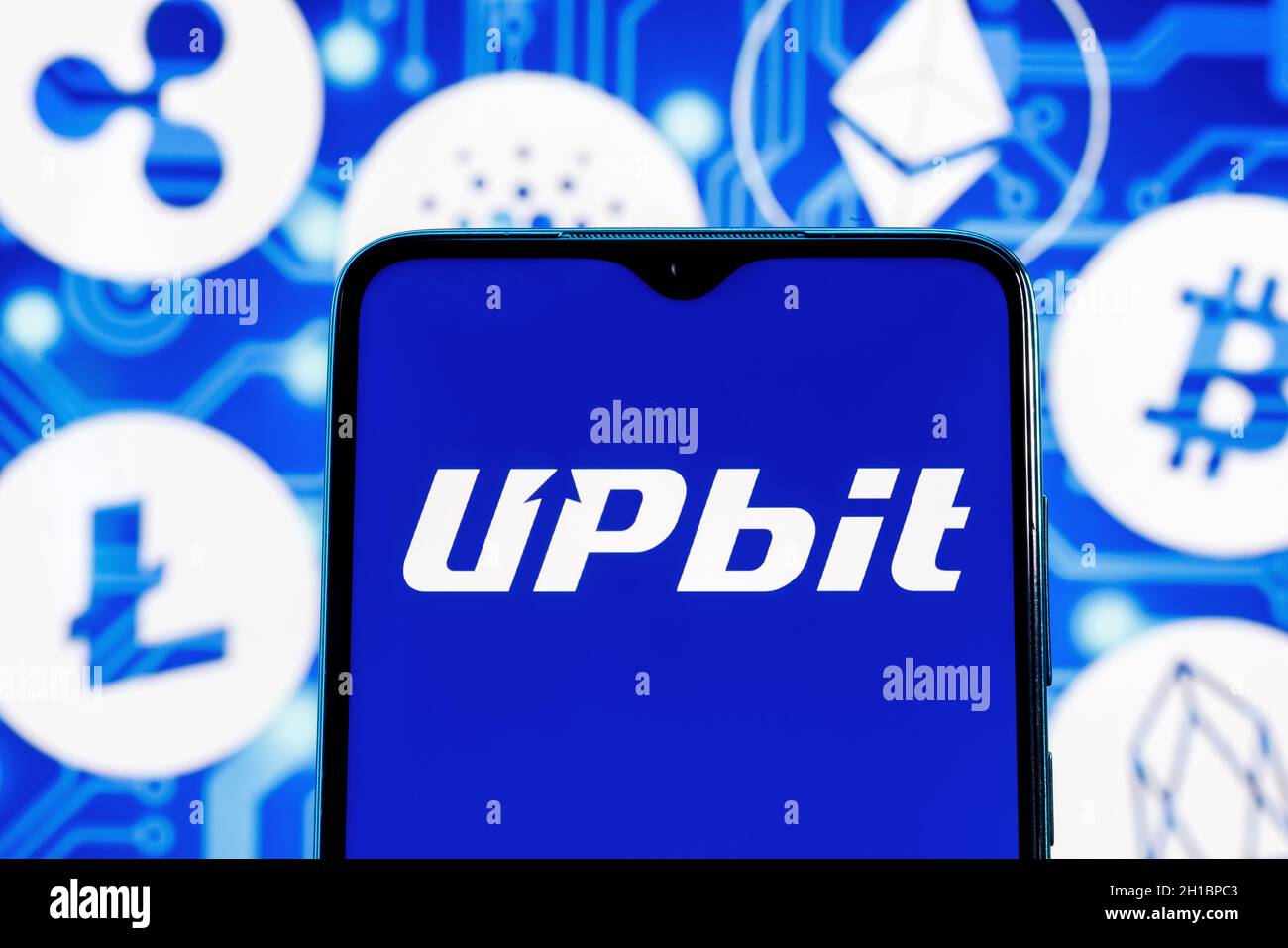 Upbit logo on smartphone screen against the background of the main ...
