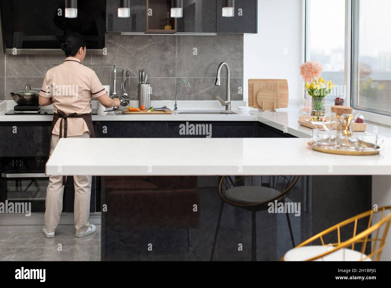 Domestic staff cooking in kitchen Stock Photo - Alamy