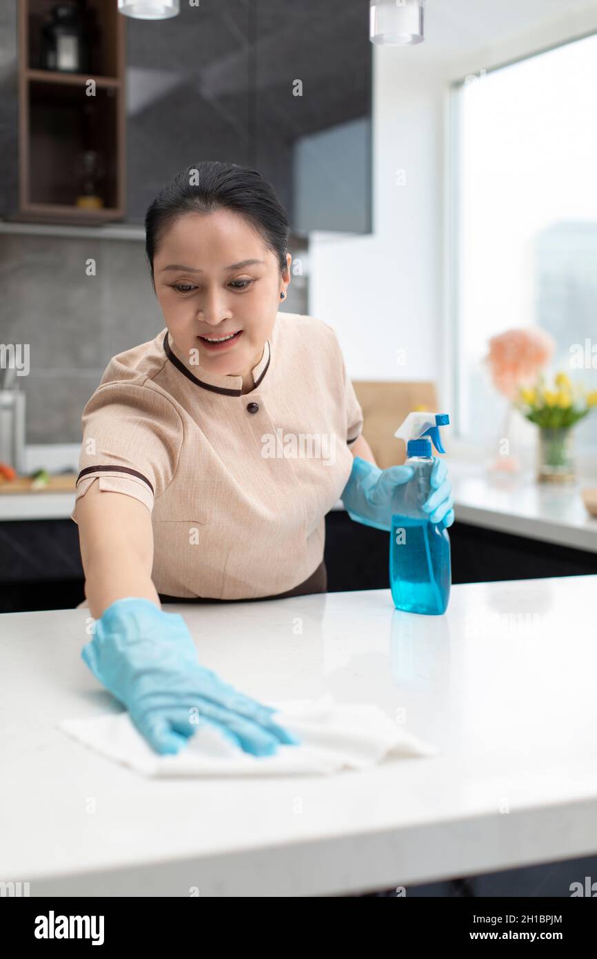 Domestic staff cleaning kitchen counter Stock Photo - Alamy