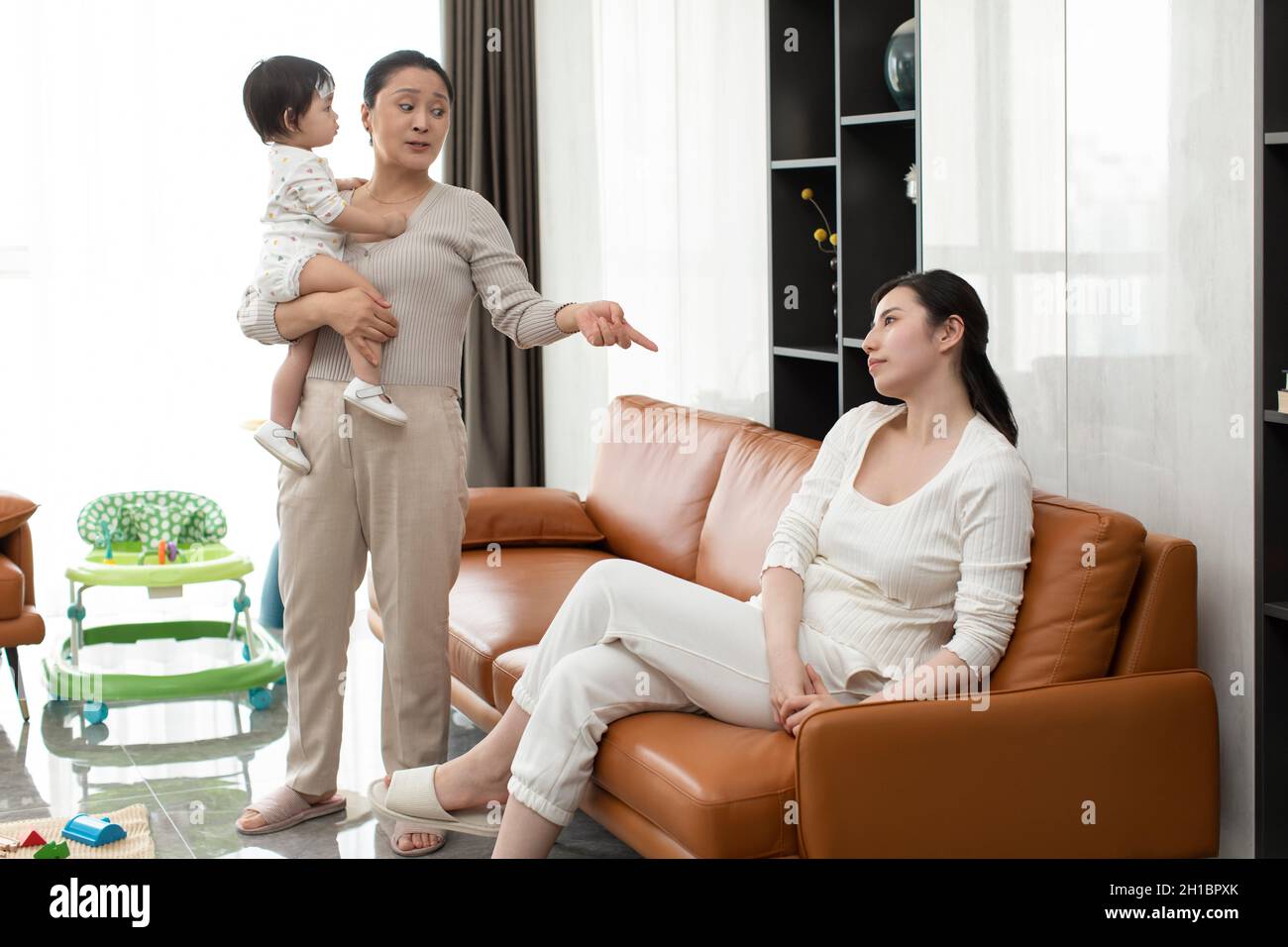 Baby's mother and grandmother arguing with each other Stock Photo - Alamy