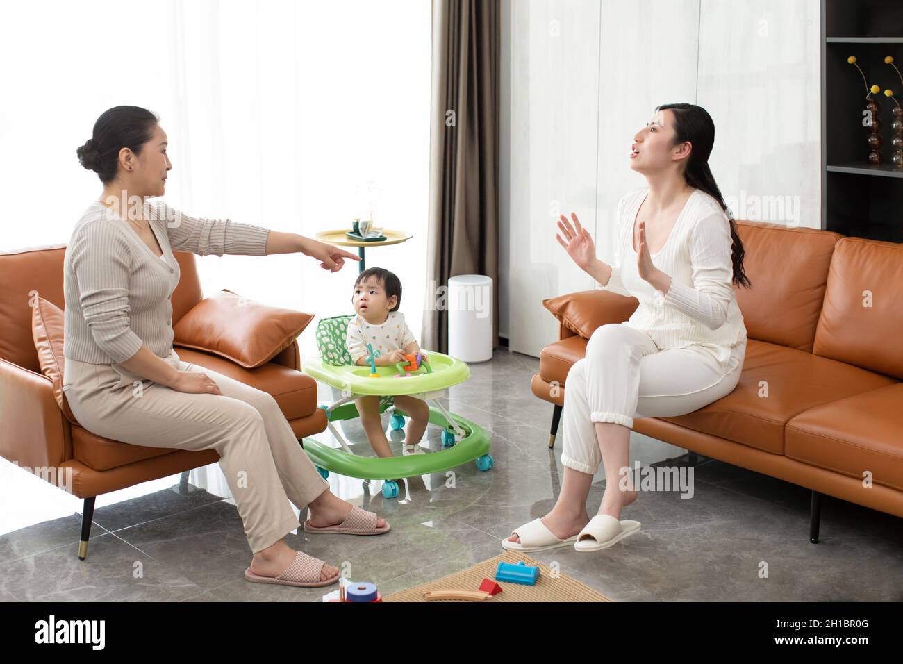 Baby's mother and grandmother arguing with each other Stock Photo - Alamy