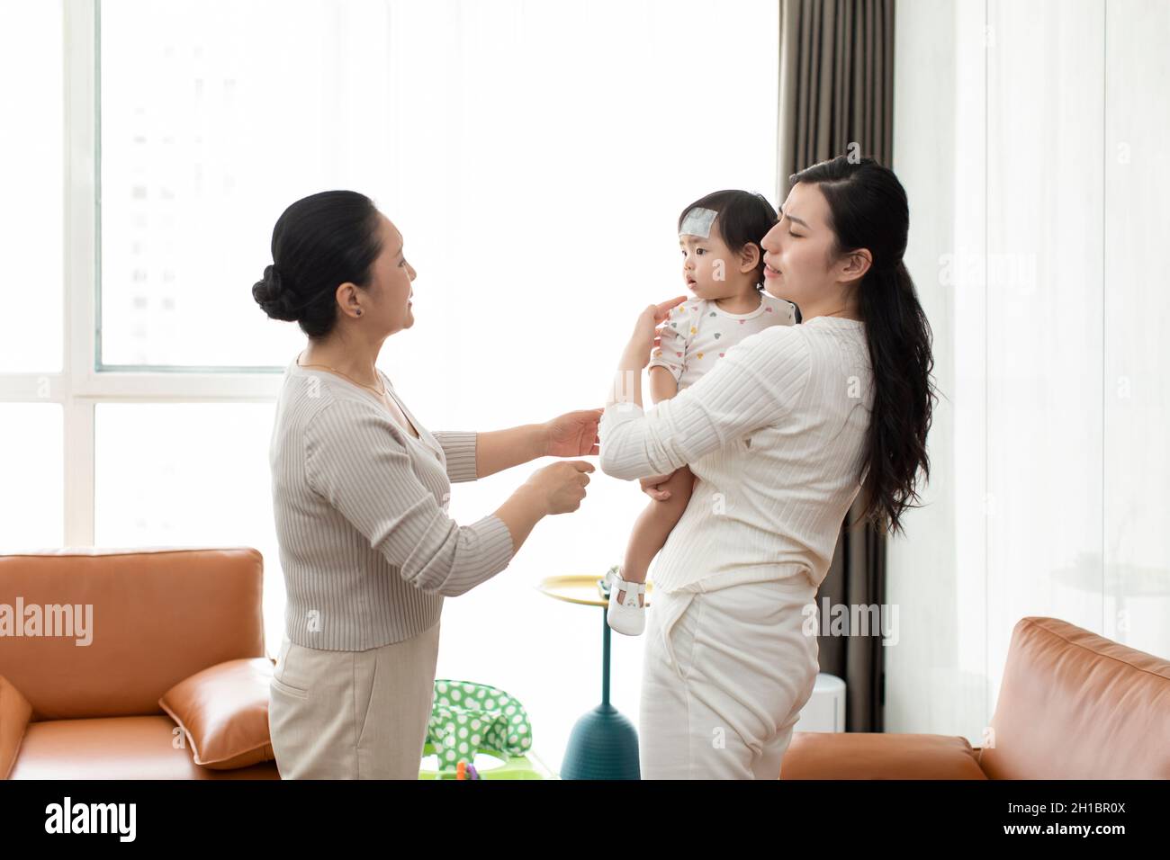 Baby's mother and grandmother arguing with each other Stock Photo - Alamy