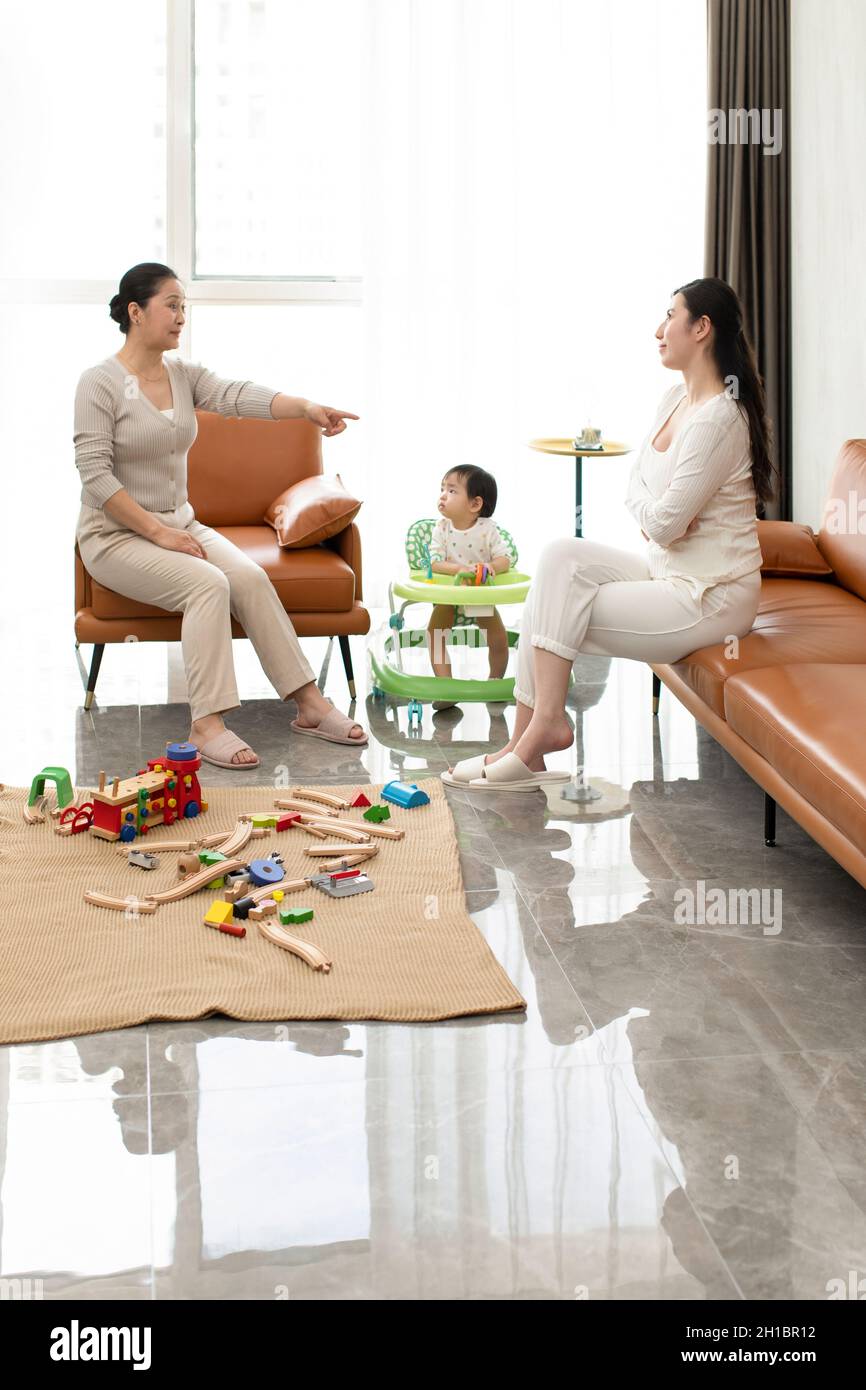 Baby's mother and grandmother arguing with each other Stock Photo - Alamy