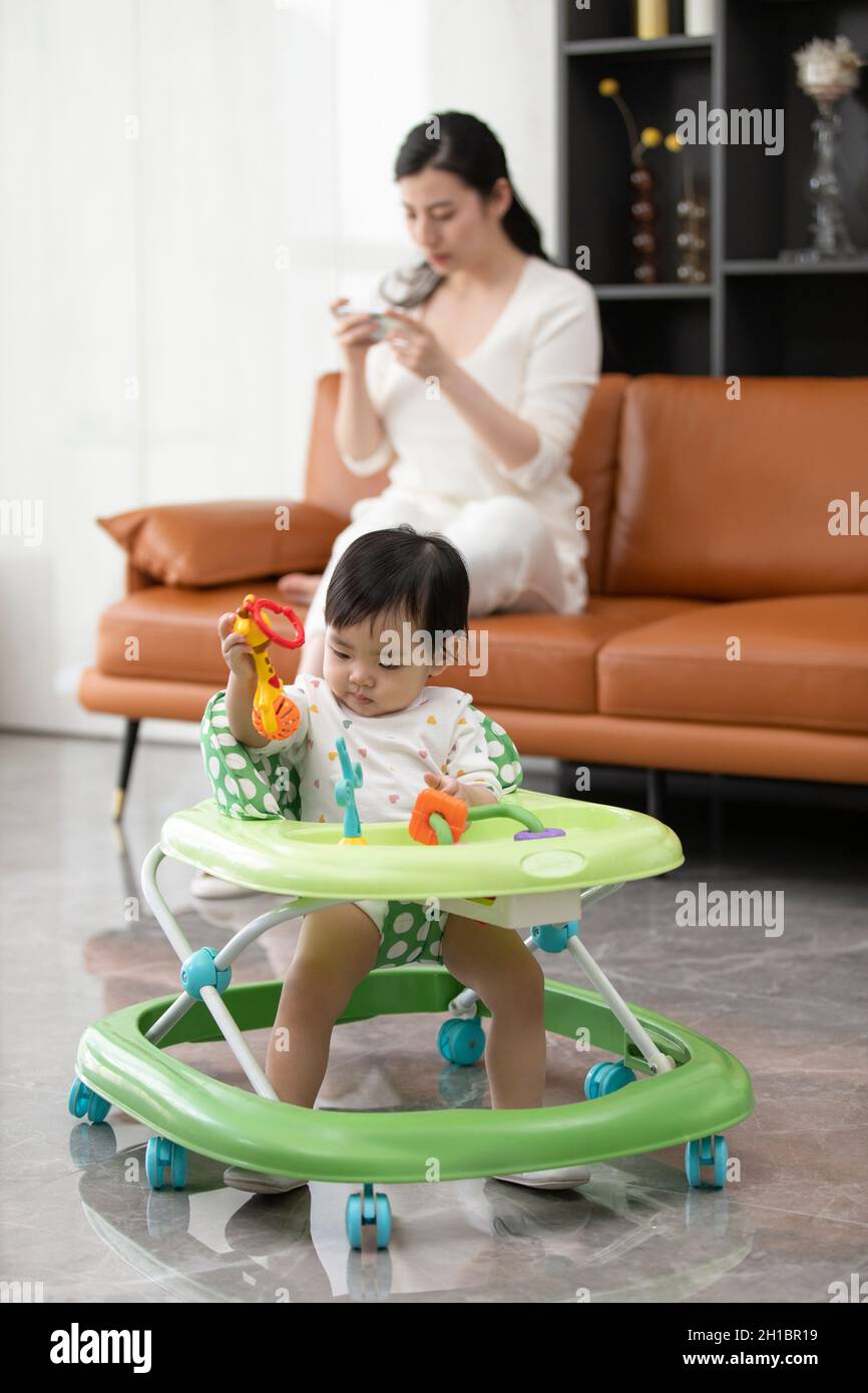 Mother ignoring baby daughter hi-res stock photography and images - Alamy