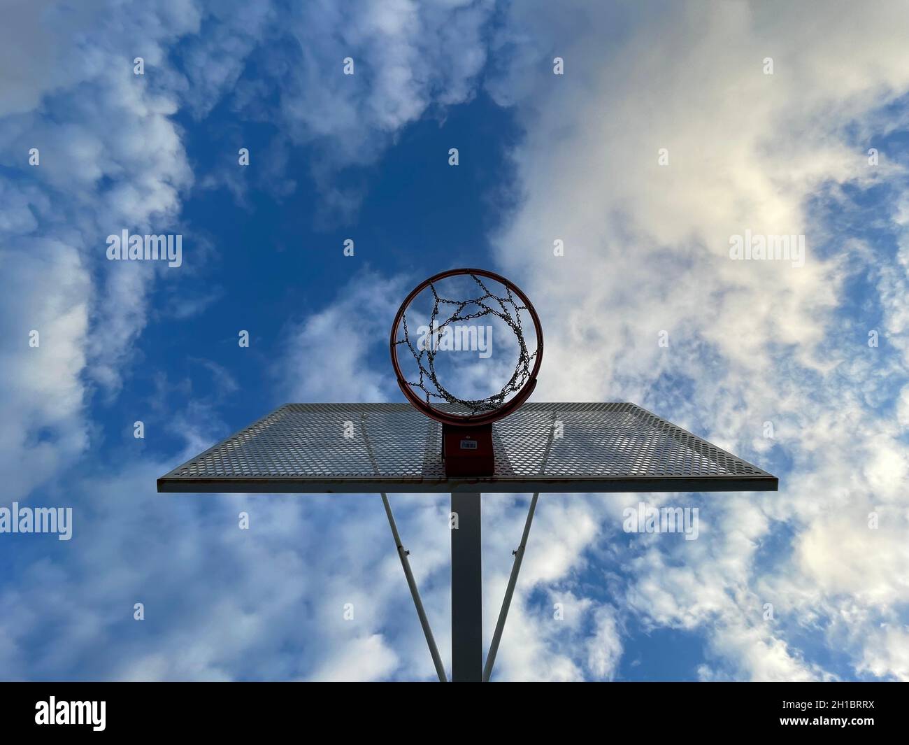 Basketball hoop seen from above with clouds and blue sky Stock Photo ...