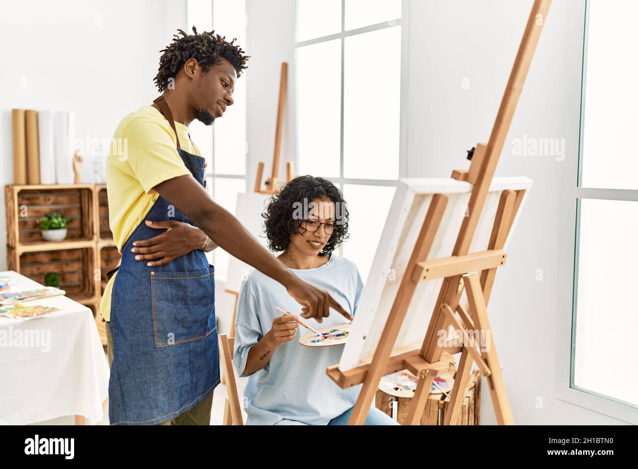 Artist teacher and student painting at art studio Stock Photo - Alamy