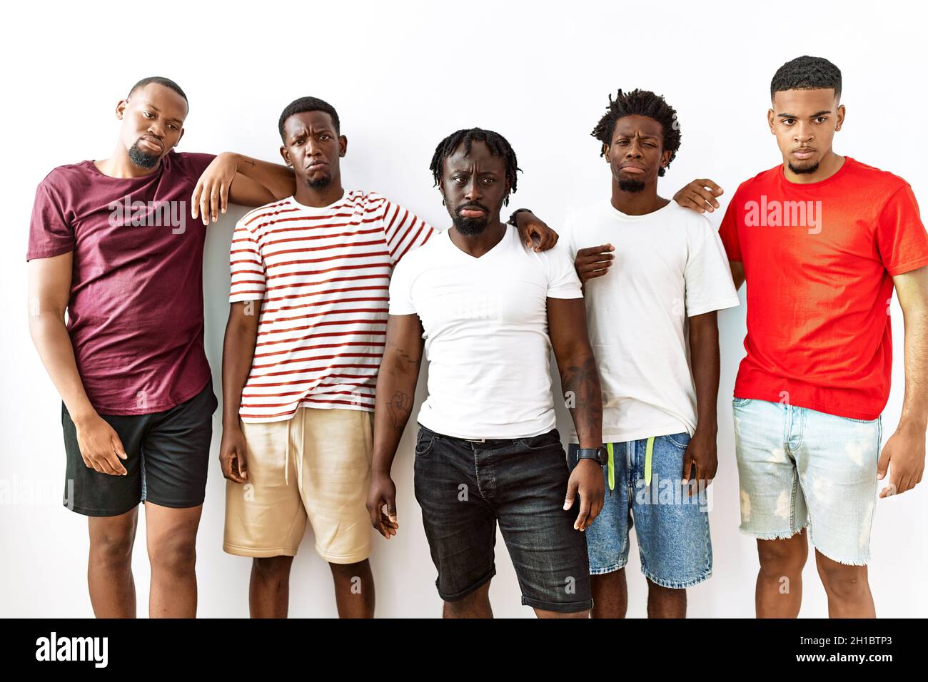 Young african group of friends standing together over isolated ...