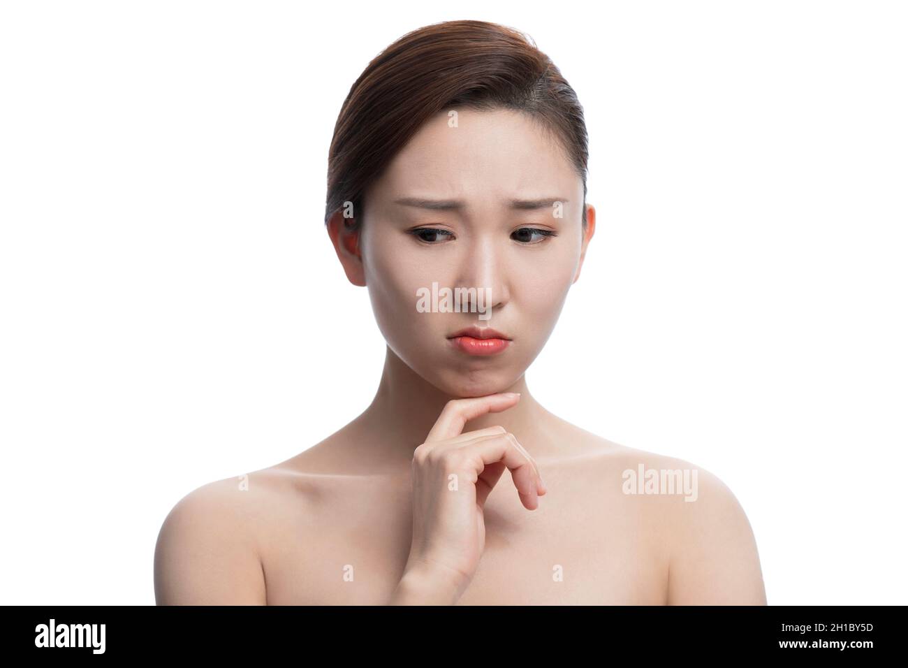 Beautiful young woman frowning Stock Photo - Alamy