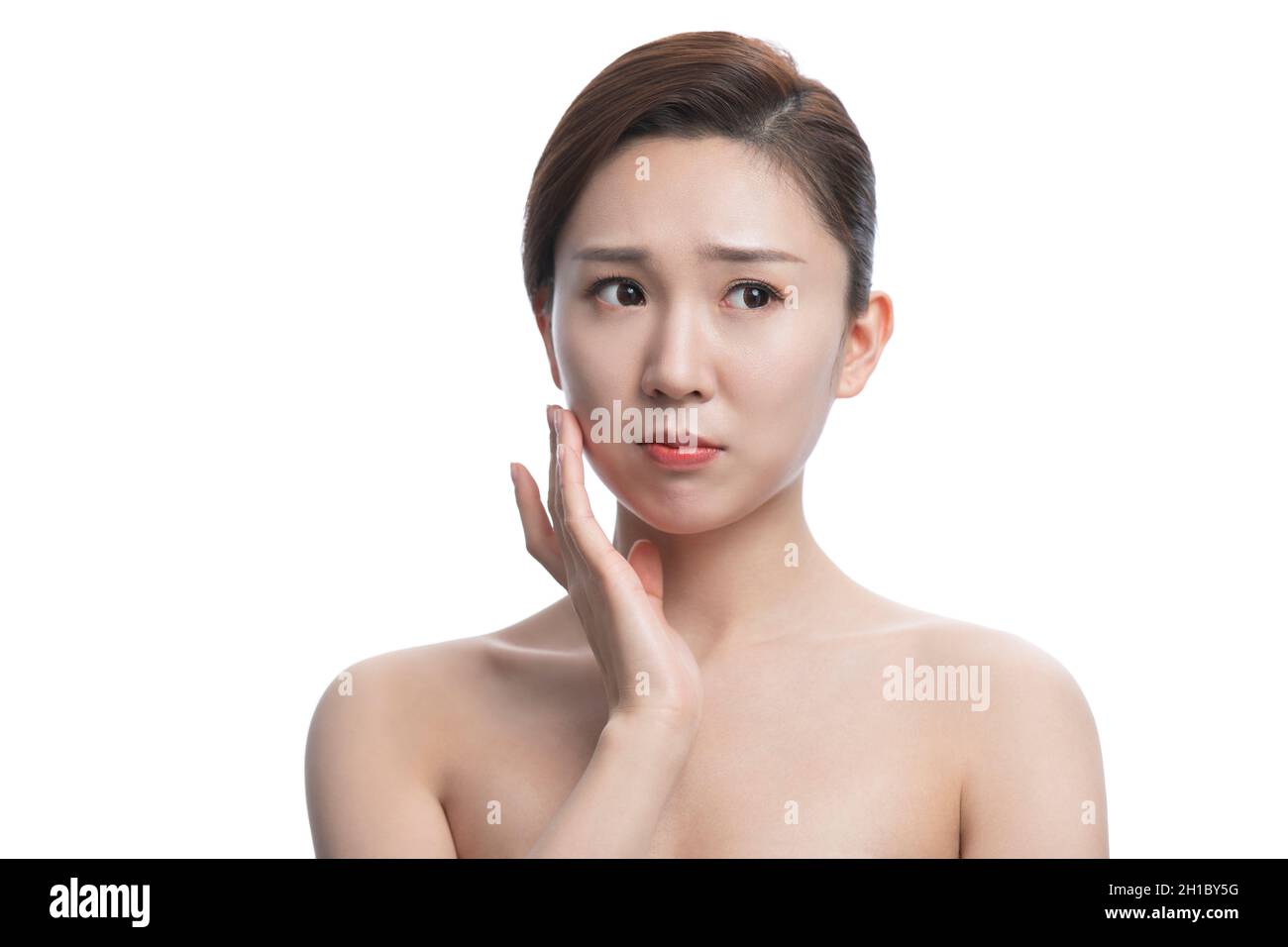 Beautiful young woman frowning Stock Photo - Alamy