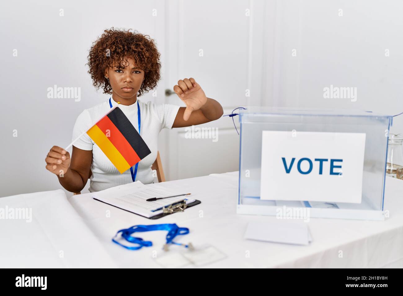 Young african american woman at political campaign election holding ...