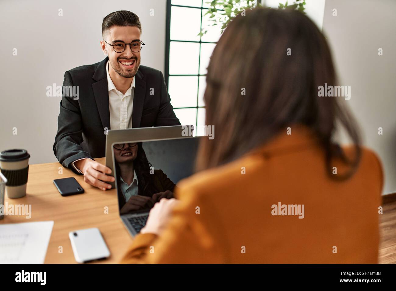 Two hispanic business workers smiling happy working at the office Stock ...