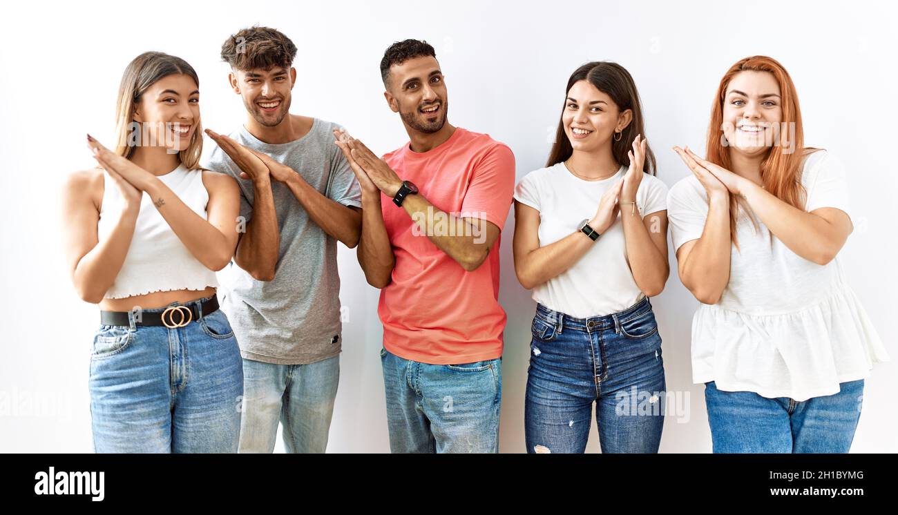 Group of young friends standing together over isolated background ...