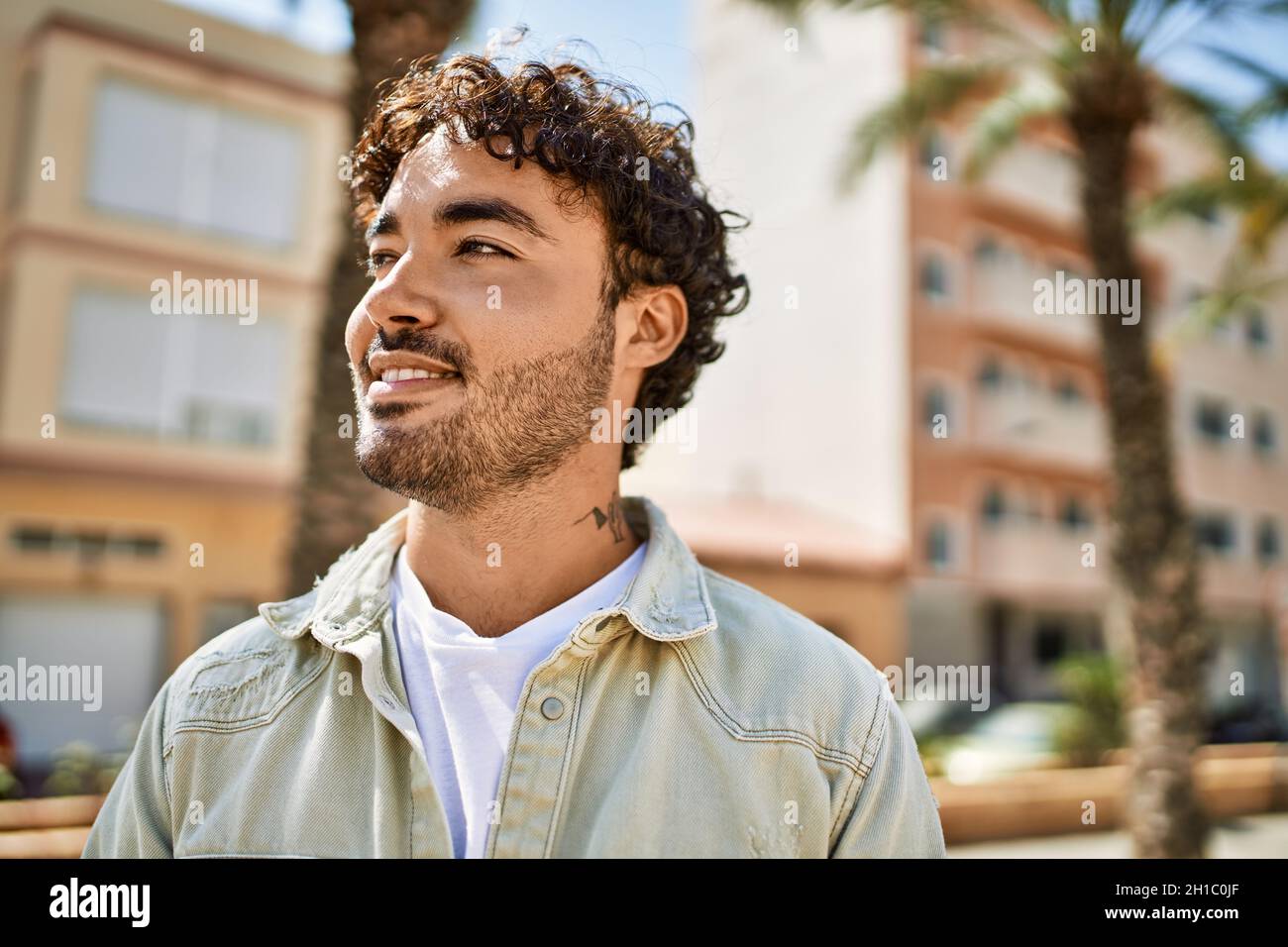 Handsome hispanic man with beard smiling happy outdoors on a sunny day ...