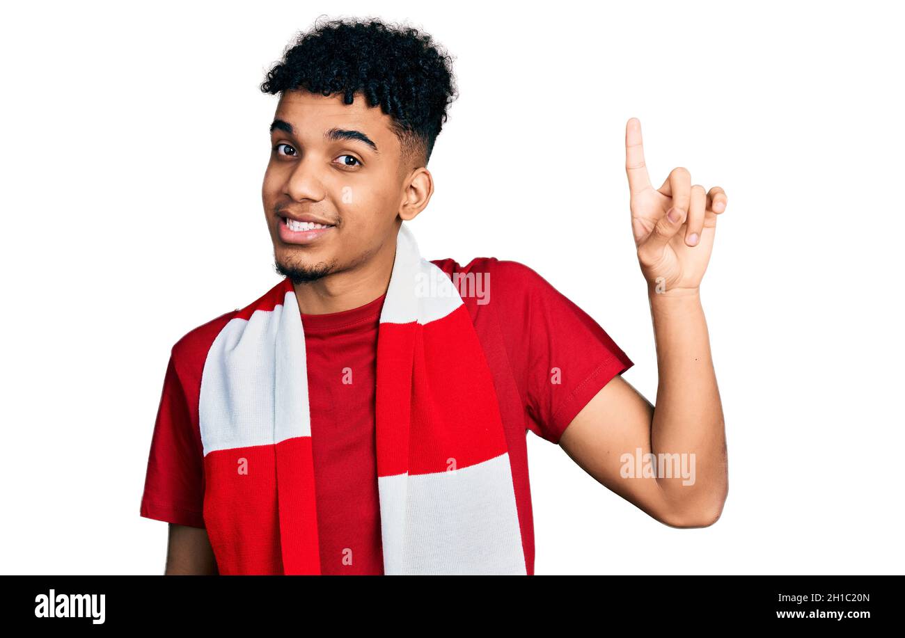 Young african american man football hooligan cheering game pointing ...
