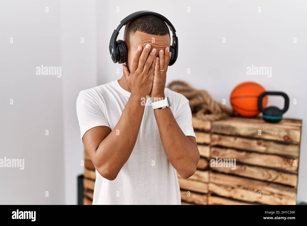 African american man listening to music using headphones at the gym ...